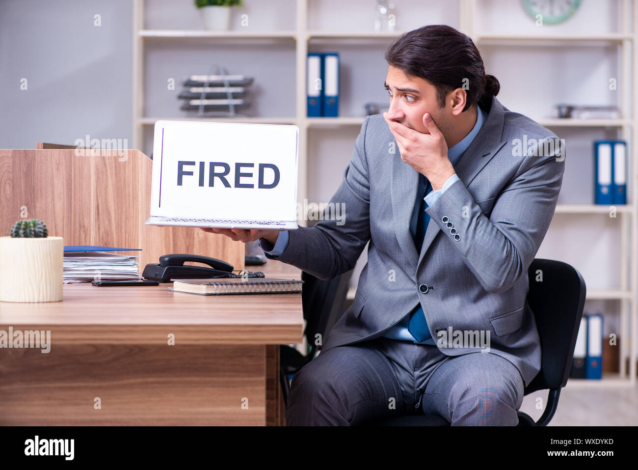 Young male employee being fired from his work Stock Photo - Alamy