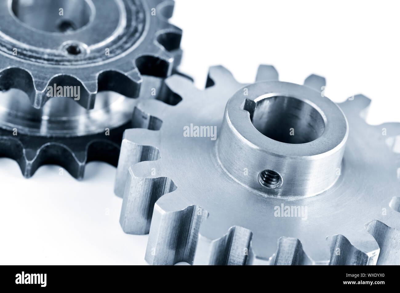 Interlocking industrial metal gears isolated on white Stock Photo - Alamy