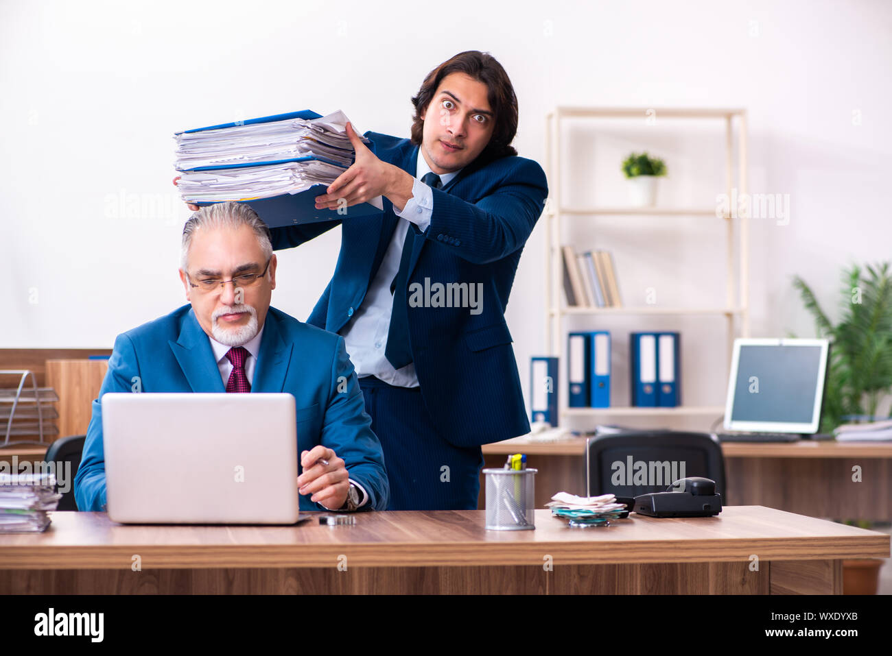 Young and old employees working together in the office Stock Photo - Alamy