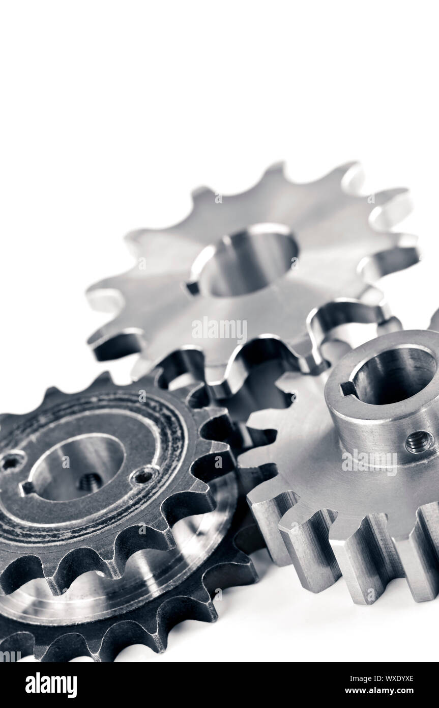 Interlocking industrial metal gears isolated on white Stock Photo - Alamy