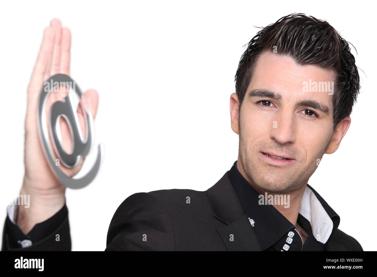 Man holding the at symbol Stock Photo - Alamy