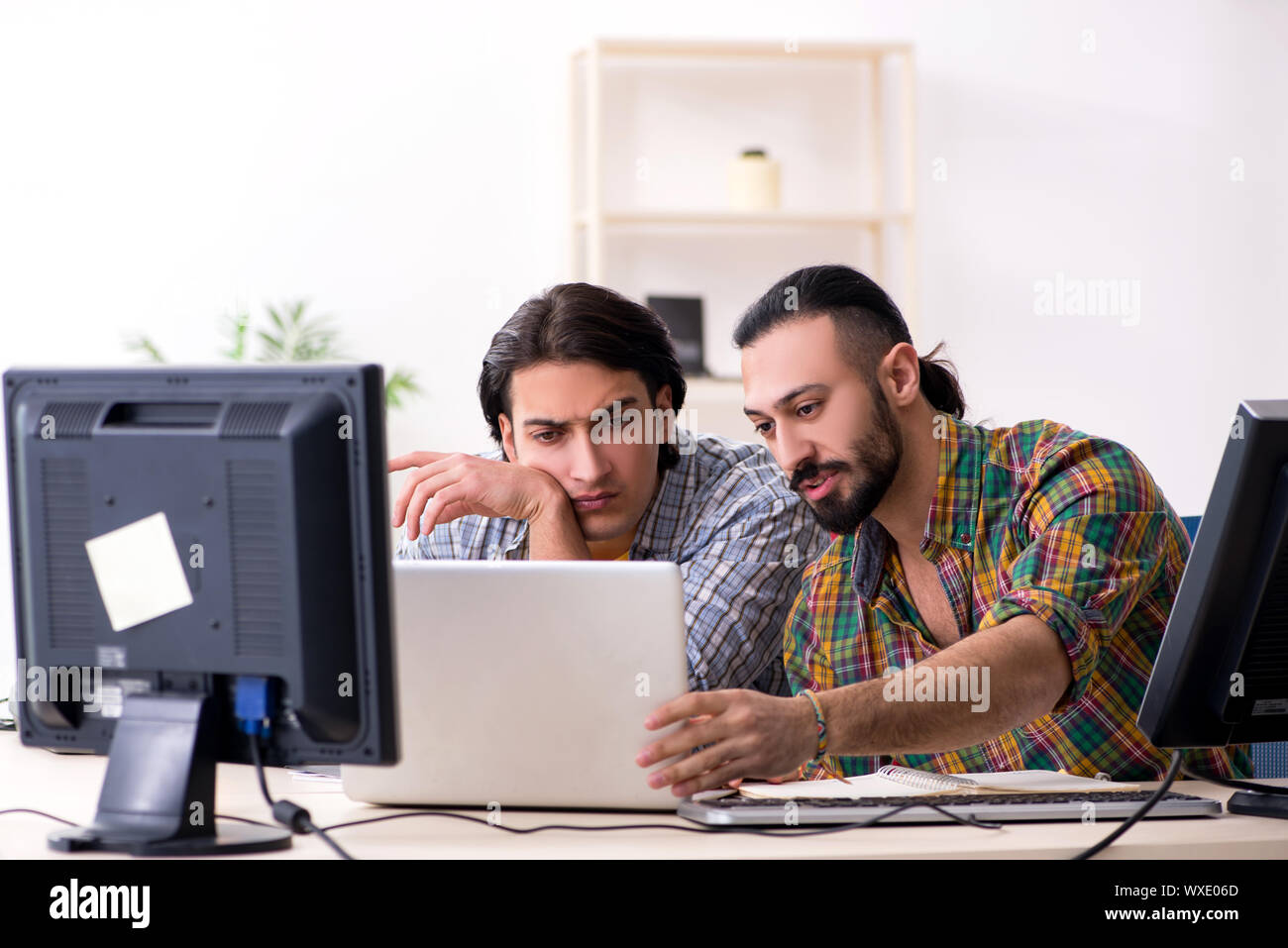 Two it specialists working in the office Stock Photo - Alamy