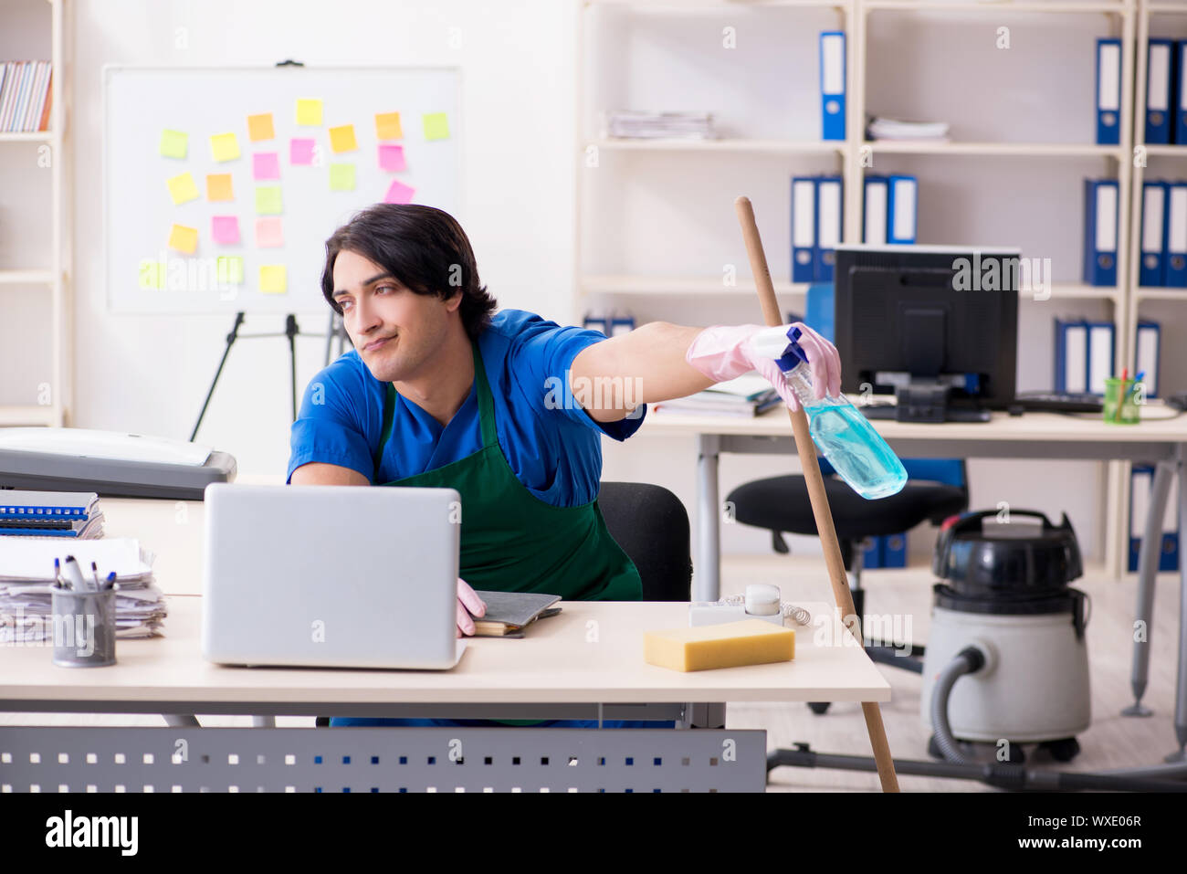 Male handsome professional cleaner working in the office Stock Photo ...