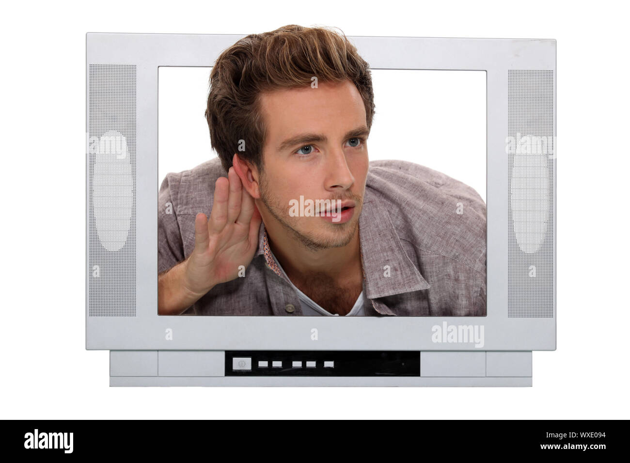young man through a TV screen listening something carefully Stock Photo ...