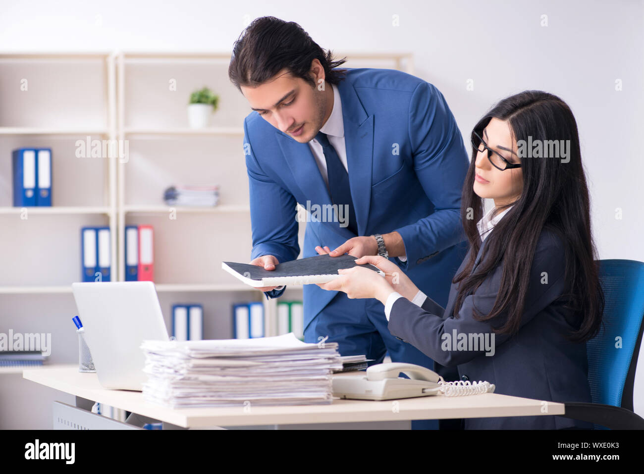 Two employees working in the office Stock Photo - Alamy