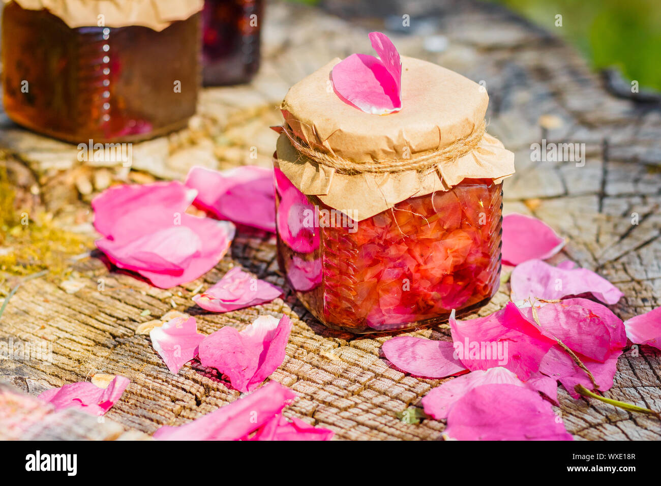 Jam from rose with rose petals on stump Stock Photo - Alamy