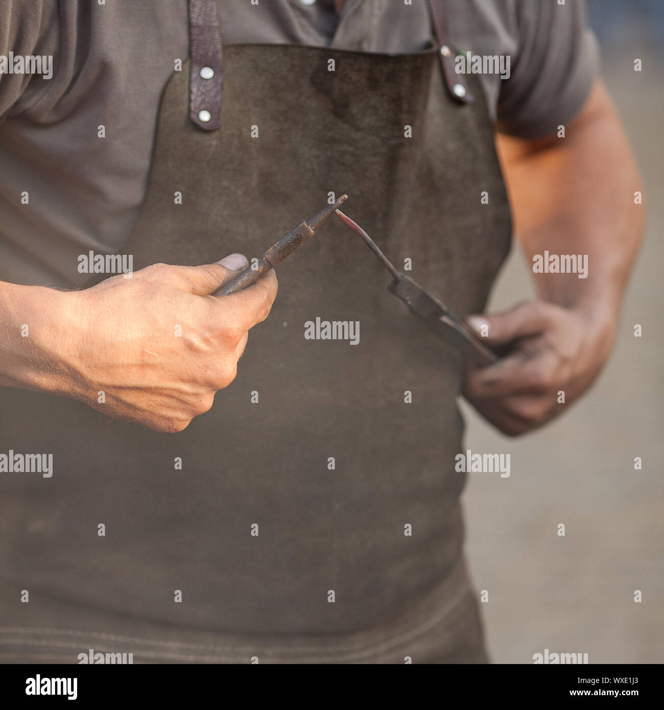 embers, fire, smoke, tools and the hands of a blacksmith Stock Photo ...