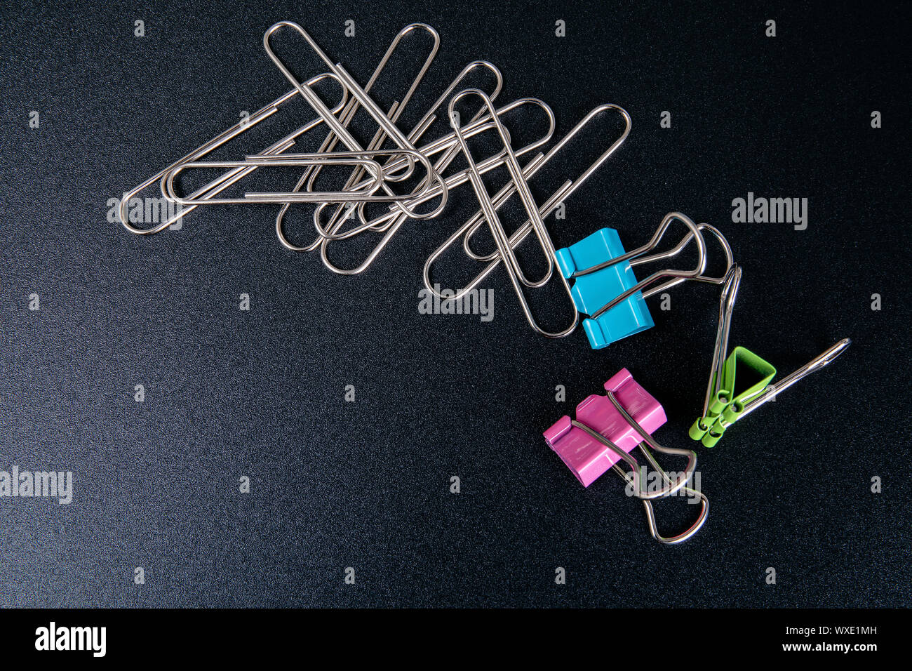 Paper and Binder clips, office supply on black background Stock Photo ...