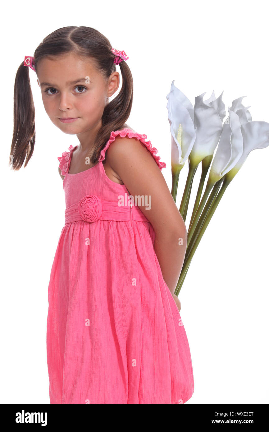 Girl with flowers behind back Stock Photo - Alamy