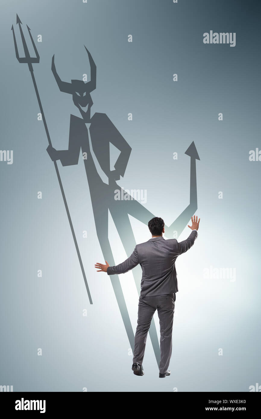 Devil hiding in the businessman - alter ego concept Stock Photo - Alamy