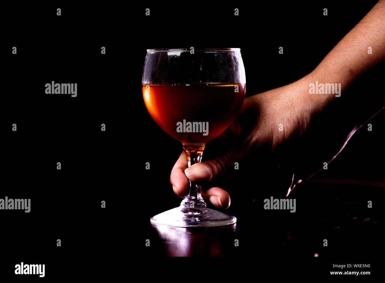 Hand holding a goblet hi-res stock photography and images - Alamy