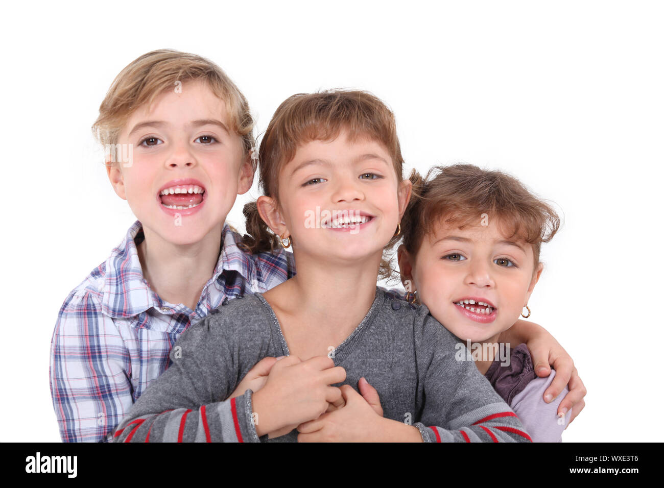 Studio portrait of three young siblings Stock Photo - Alamy