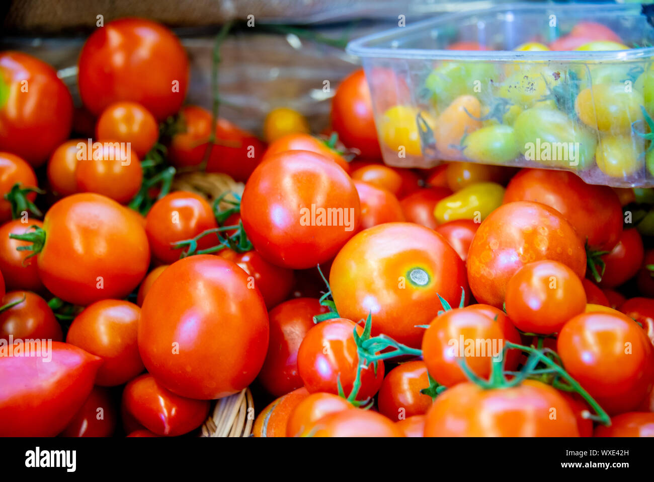 Tomatoes at the market display stall Stock Photo - Alamy