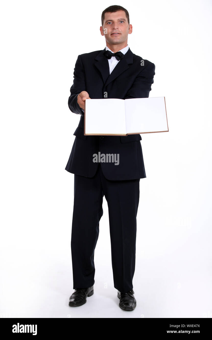 Waitor holding book Stock Photo - Alamy