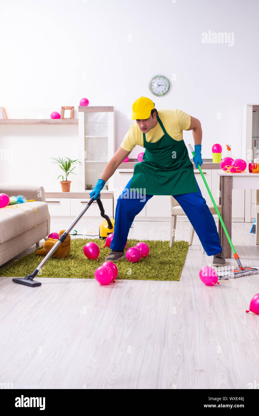 Young male contractor doing housework after party hi-res stock ...
