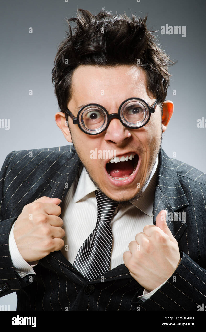 Funny nerd businessman in dark studio Stock Photo - Alamy