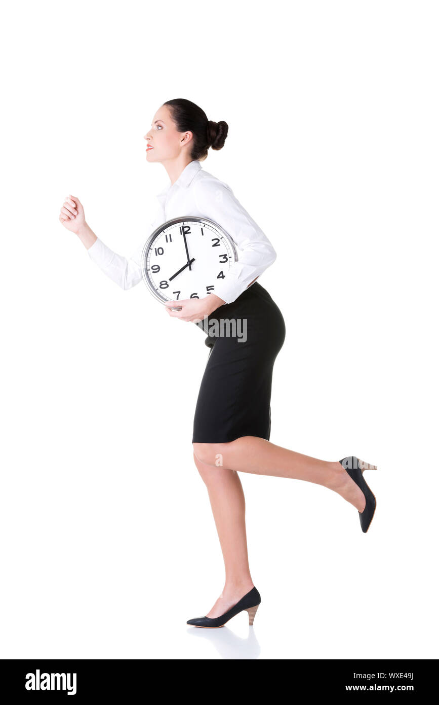 Business woman running late with clock under arm Stock Photo - Alamy