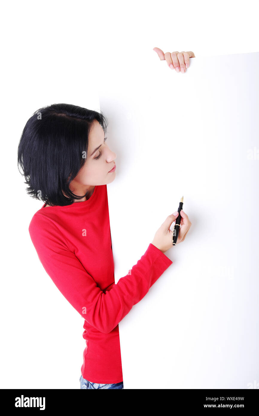 Happy beautiful woman writing with a pen on blank board. Student or ...
