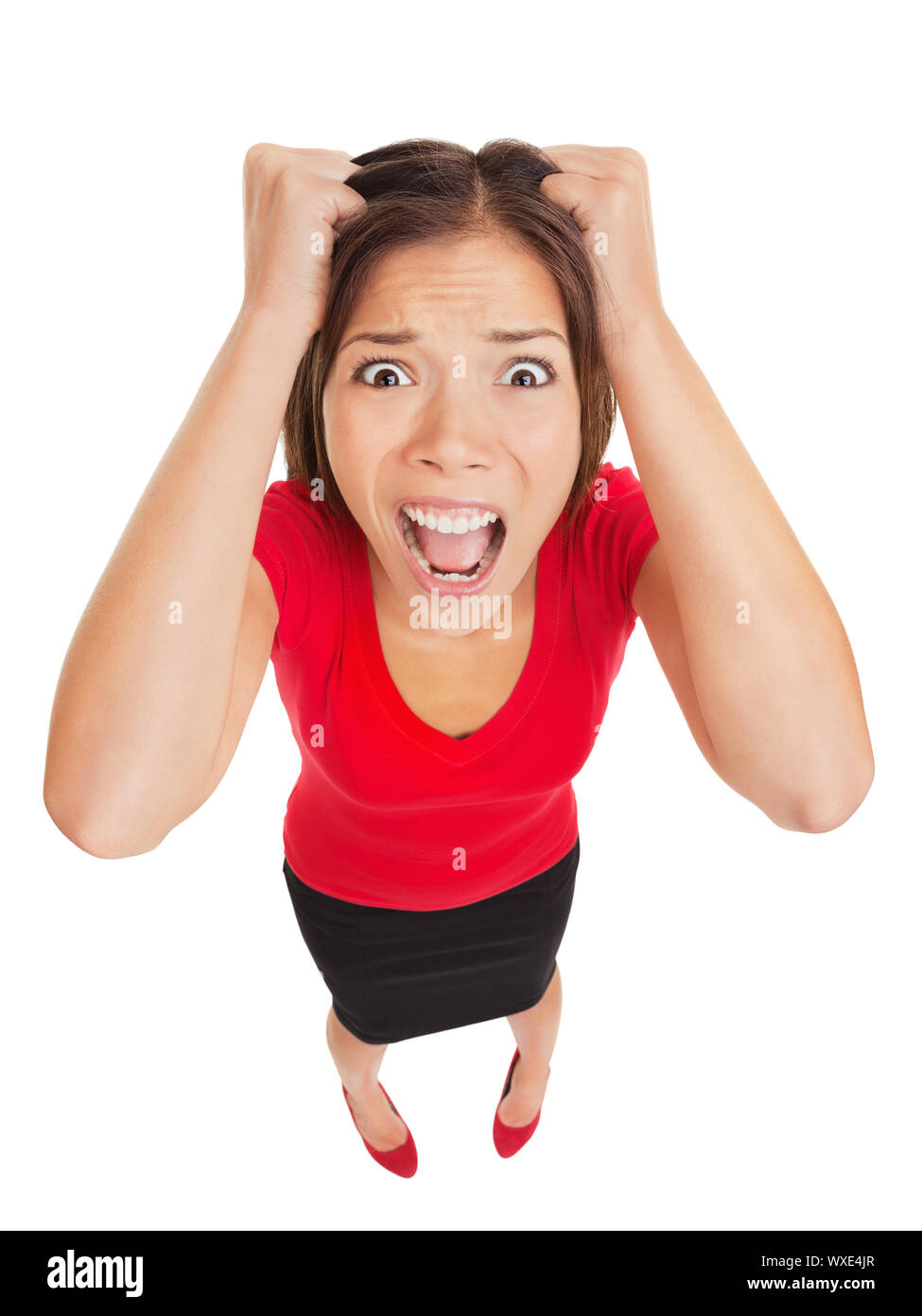 Appalled woman with a terrified expression looking up into the camera ...