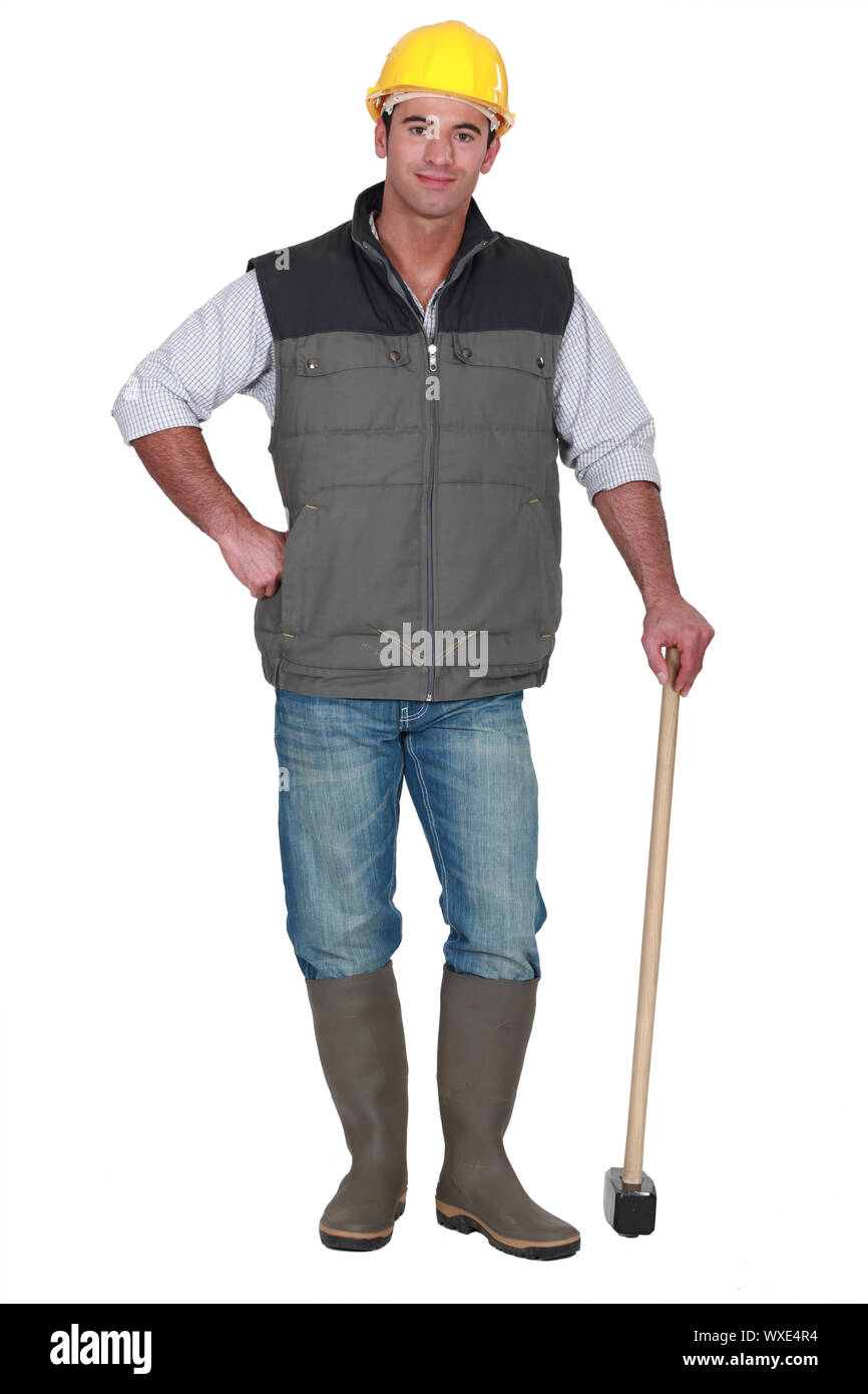 Construction worker posing with sledge-hammer Stock Photo - Alamy