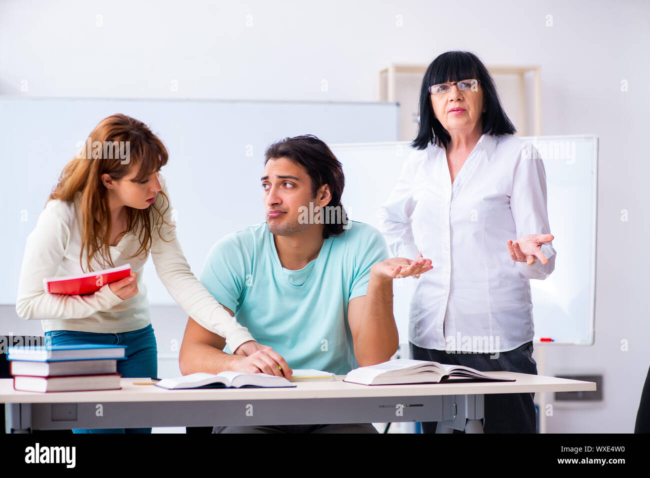 Old teacher and students in the classroom Stock Photo - Alamy