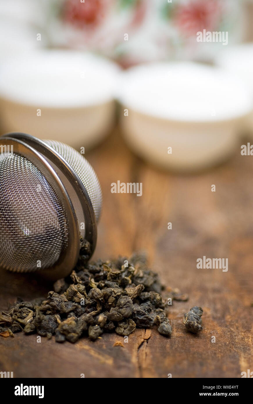 dry green chinese tea set,with strainer closeup,cups and teapot on ...