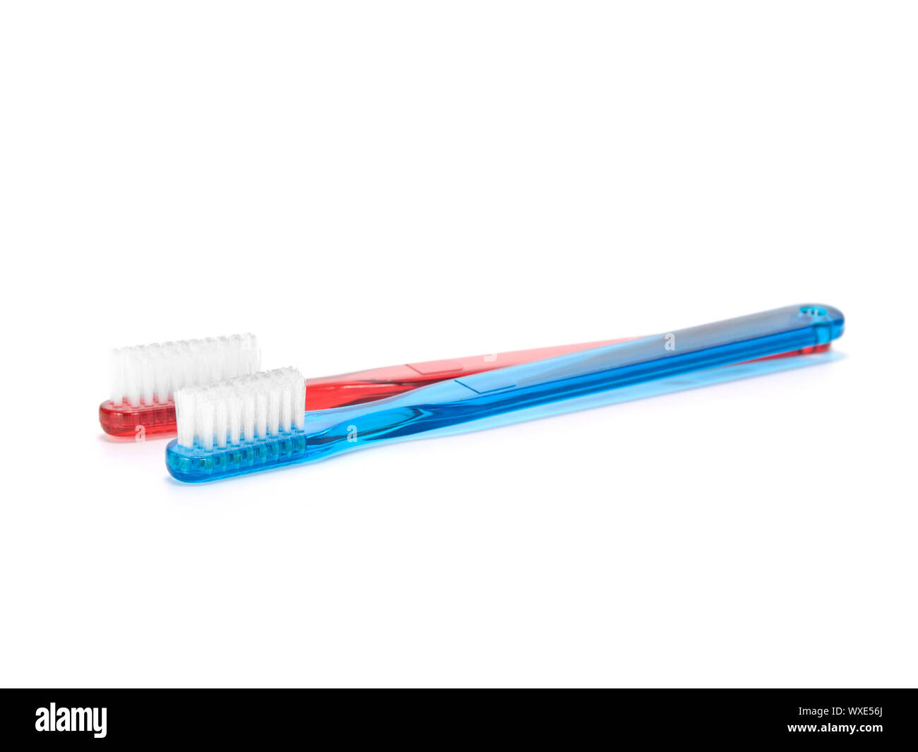 A blue and a red toothbrush isolated on white background Stock Photo ...