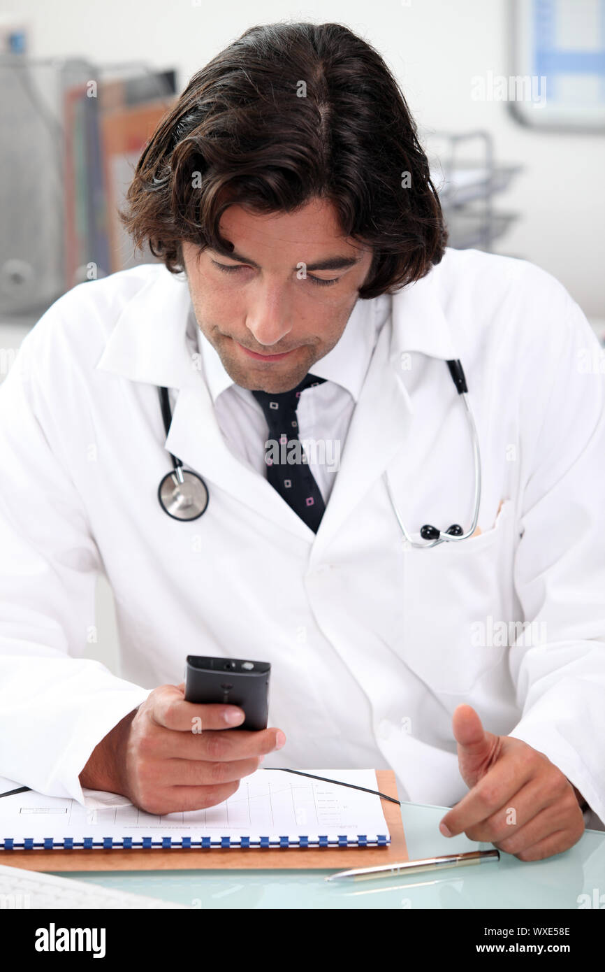 Doctor reading message Stock Photo - Alamy