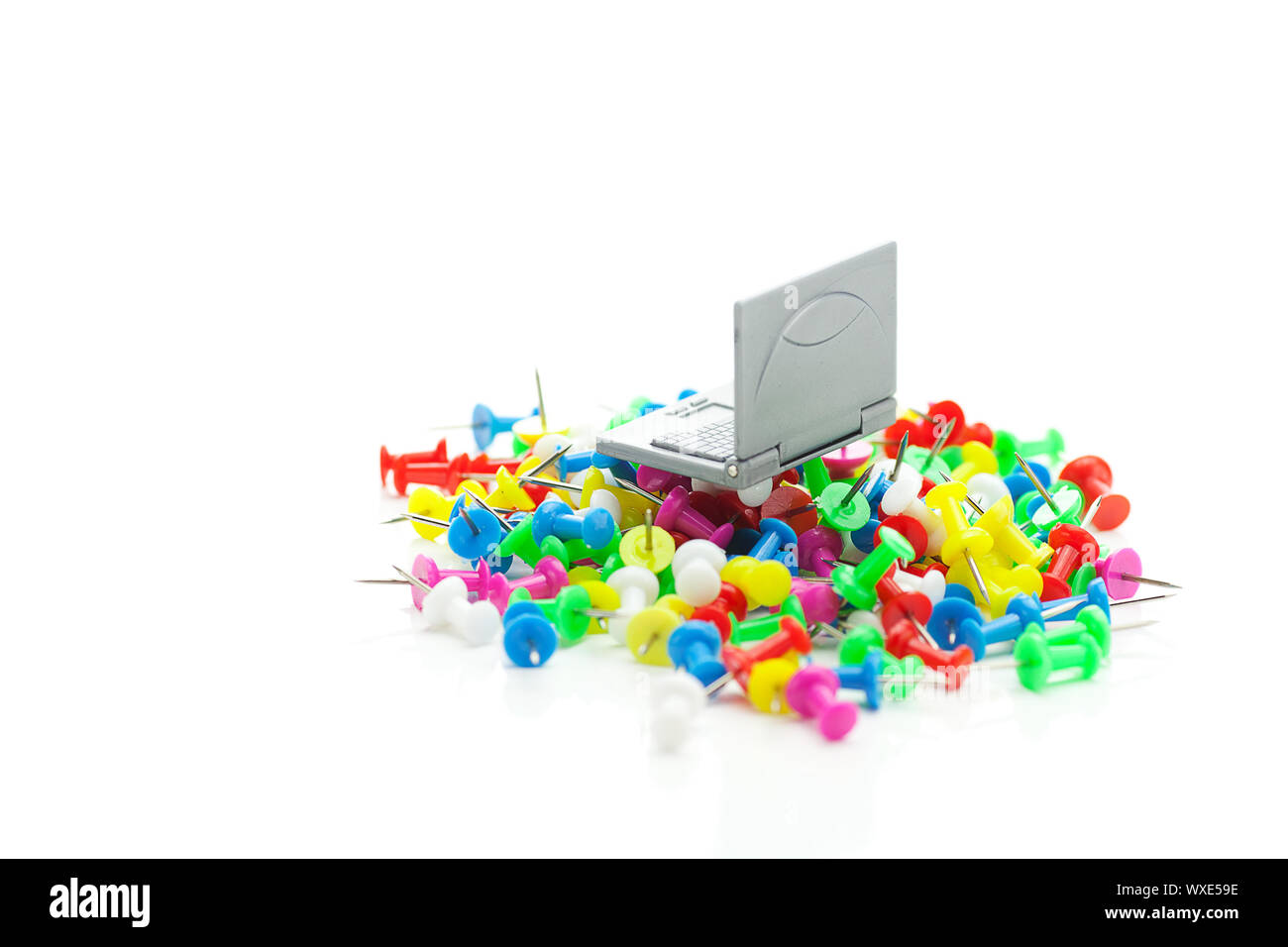 miniature laptop and colored pins isolated on white Stock Photo - Alamy