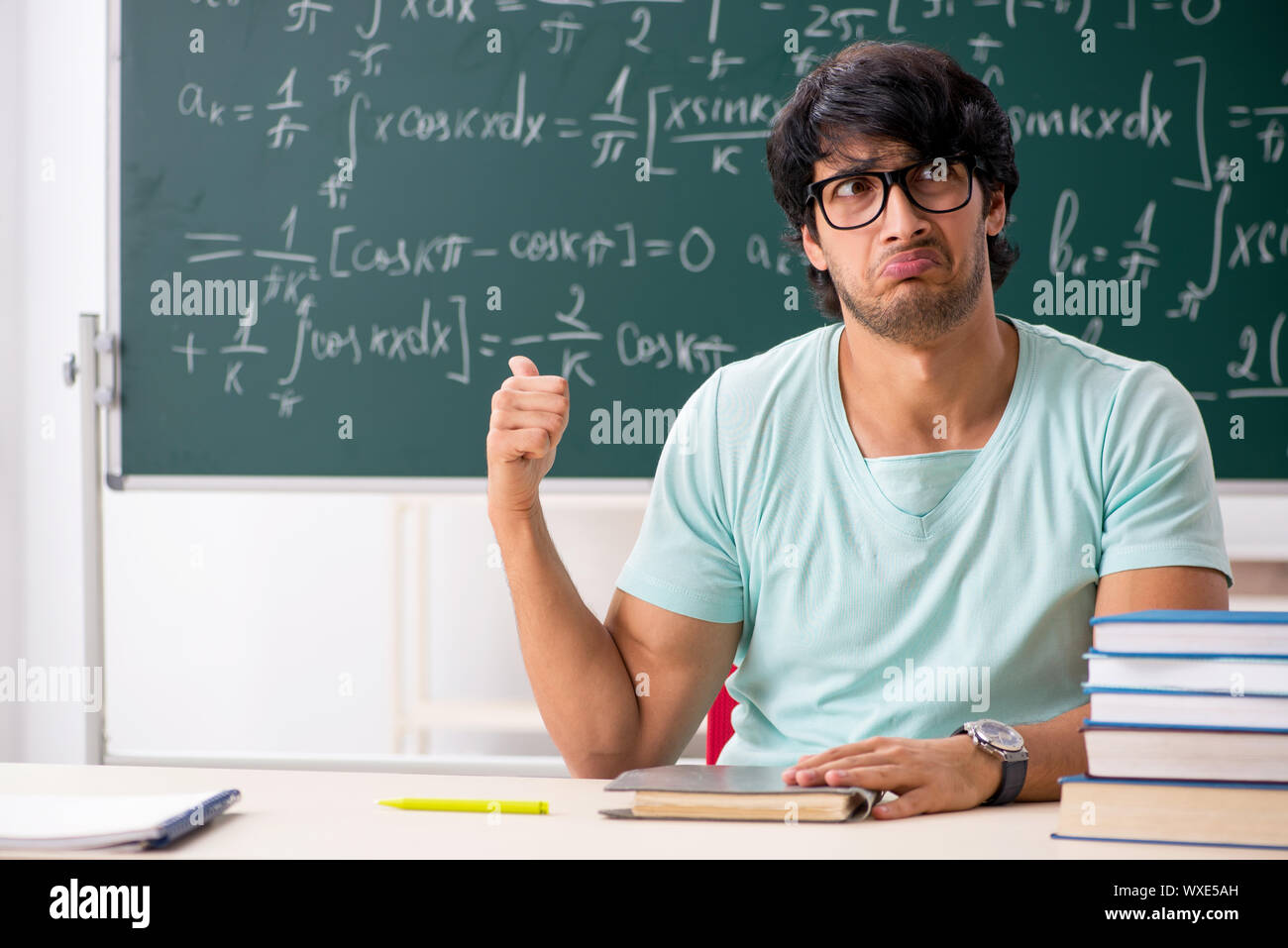 Young male student mathematician in front of chalkboard Stock Photo - Alamy
