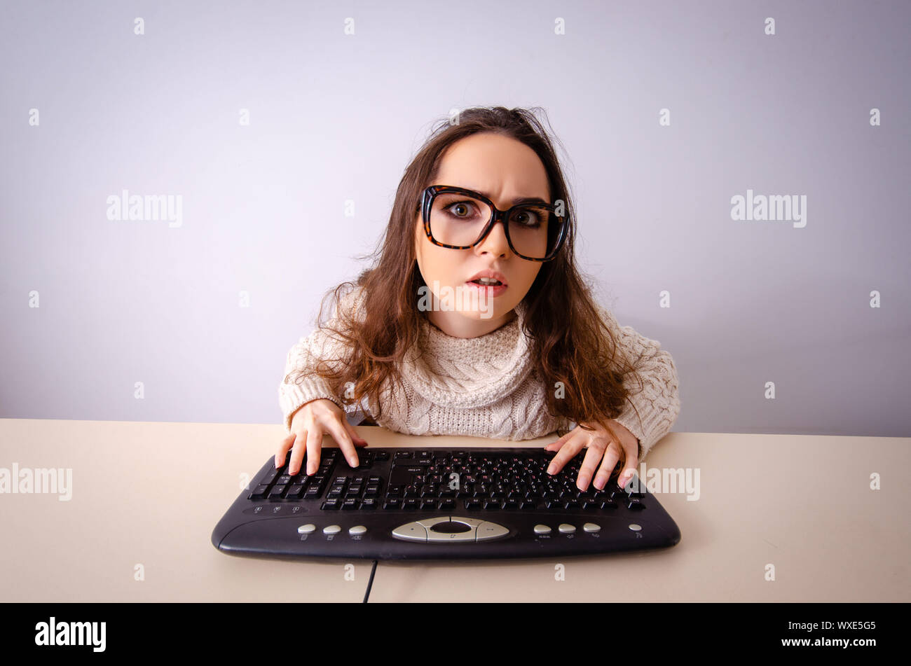 Funny nerd girl working on computer Stock Photo - Alamy
