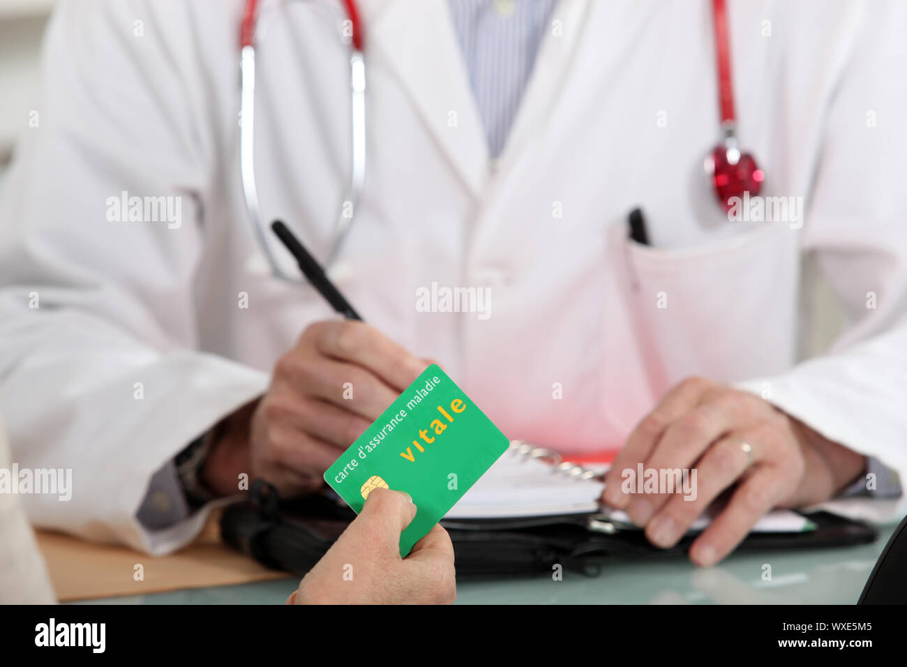 Patient paying for a medical consultation Stock Photo - Alamy