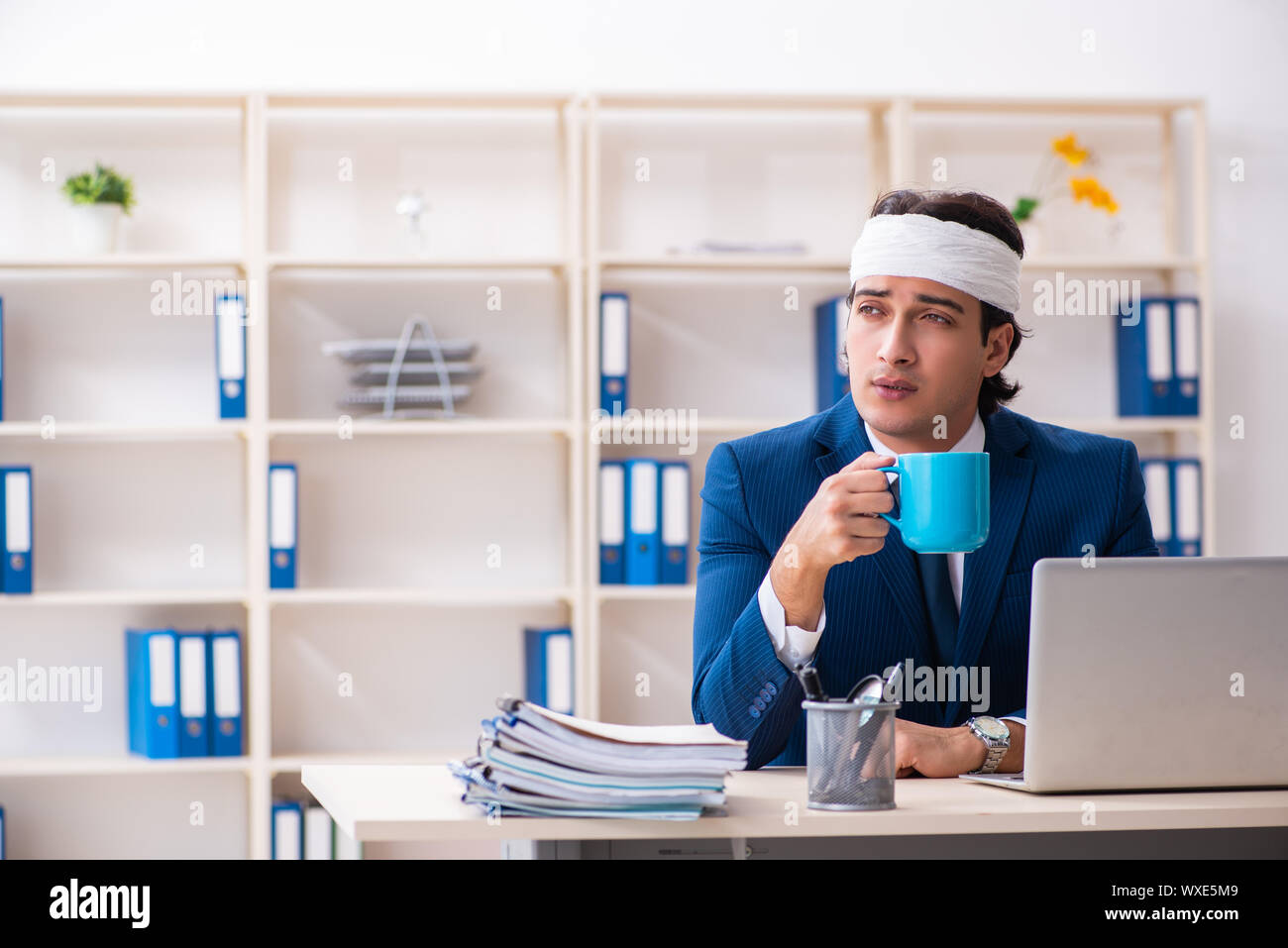 Head injured male employee working in the office Stock Photo - Alamy