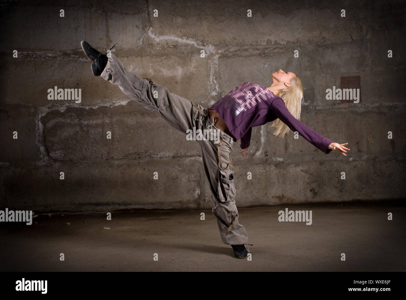 Beautiful hip hop girl dancing over grey brick wall Stock Photo - Alamy