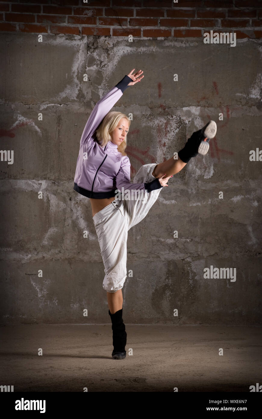Beautiful hip hop girl dancing over grey brick wall Stock Photo - Alamy