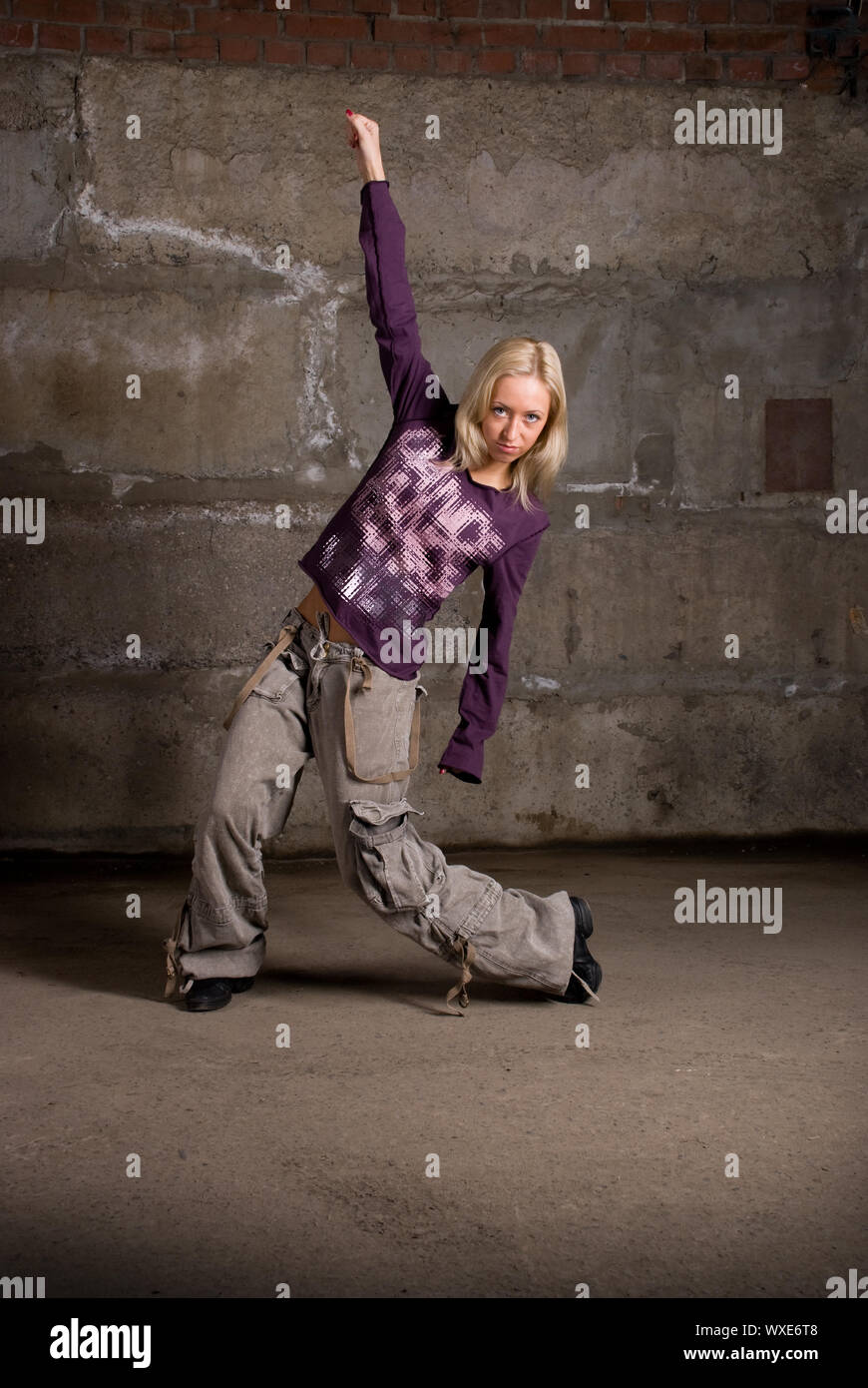 Beautiful hip hop girl dancing over grey brick wall Stock Photo - Alamy