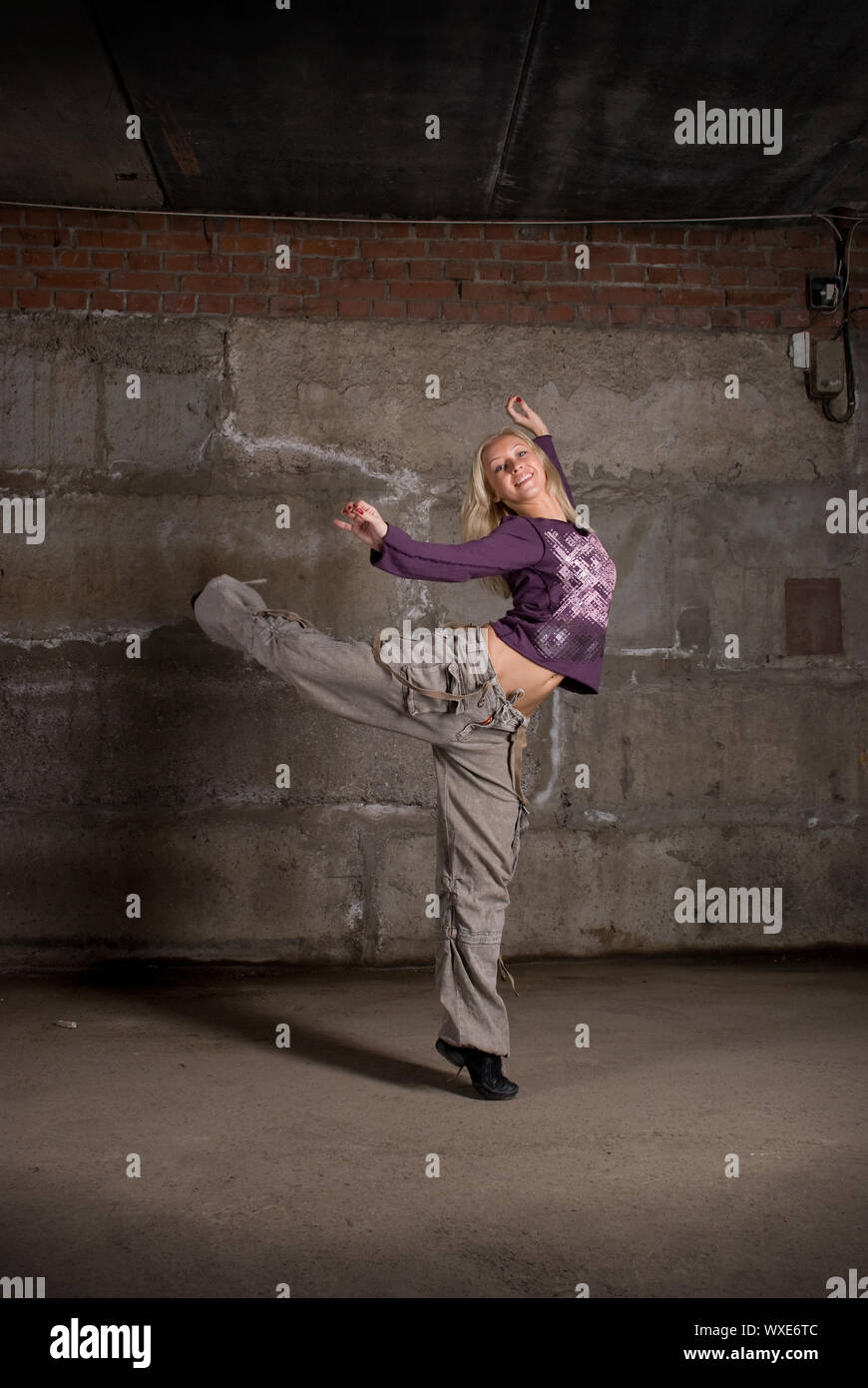 Beautiful hip hop girl dancing over grey brick wall Stock Photo - Alamy
