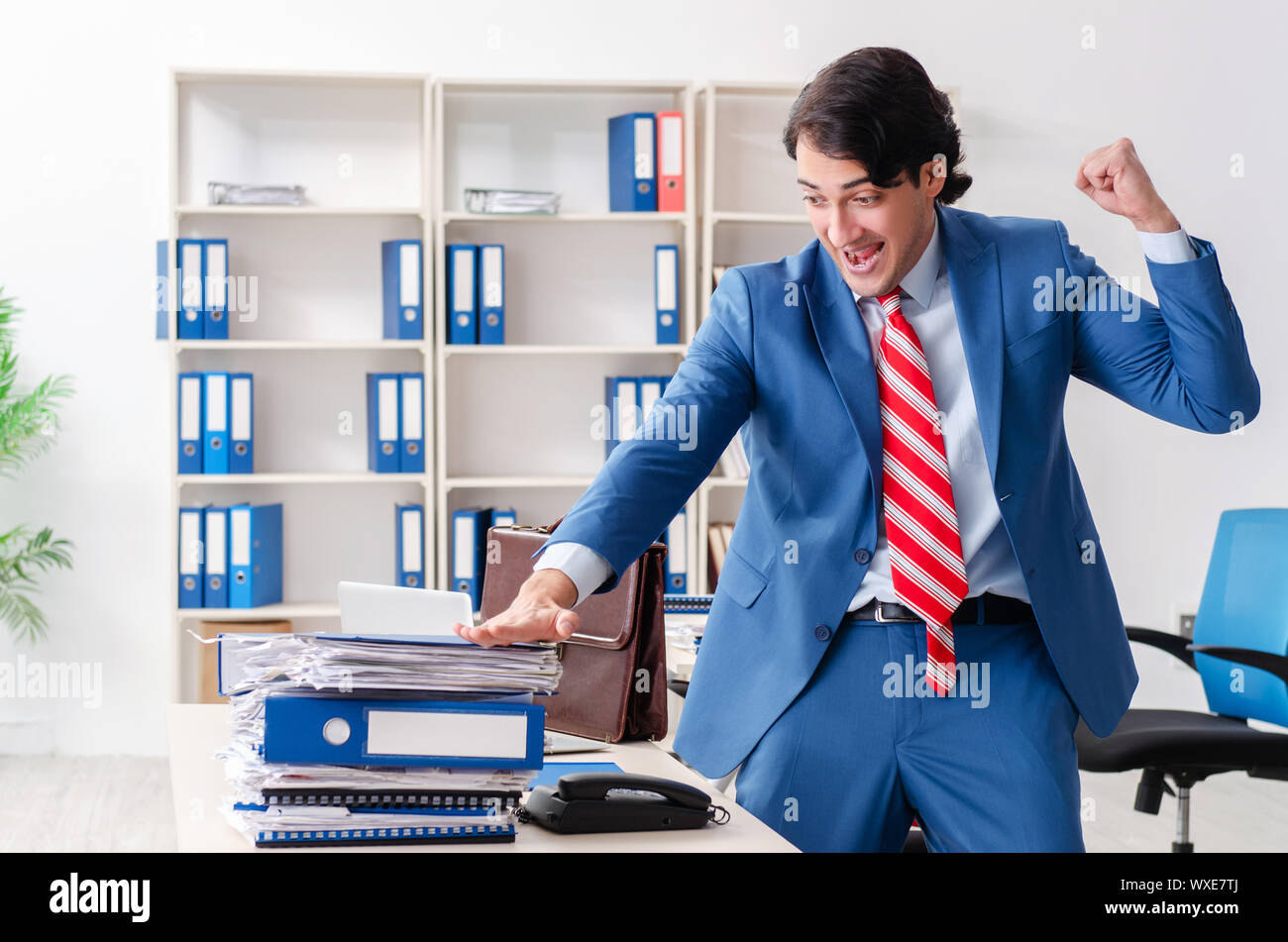Young happy male employee in the office Stock Photo - Alamy
