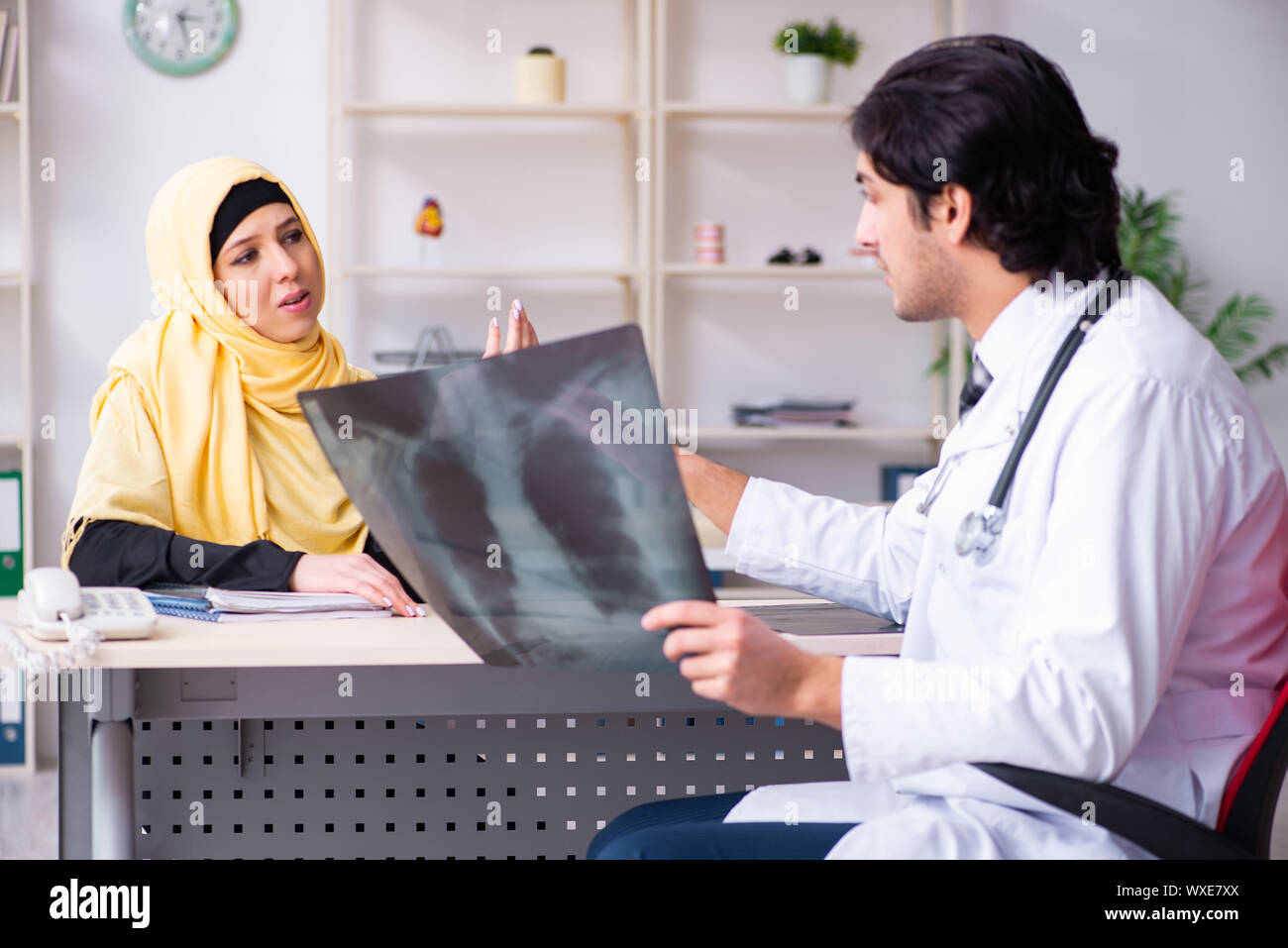 Female arab patient visiting male doctor Stock Photo - Alamy