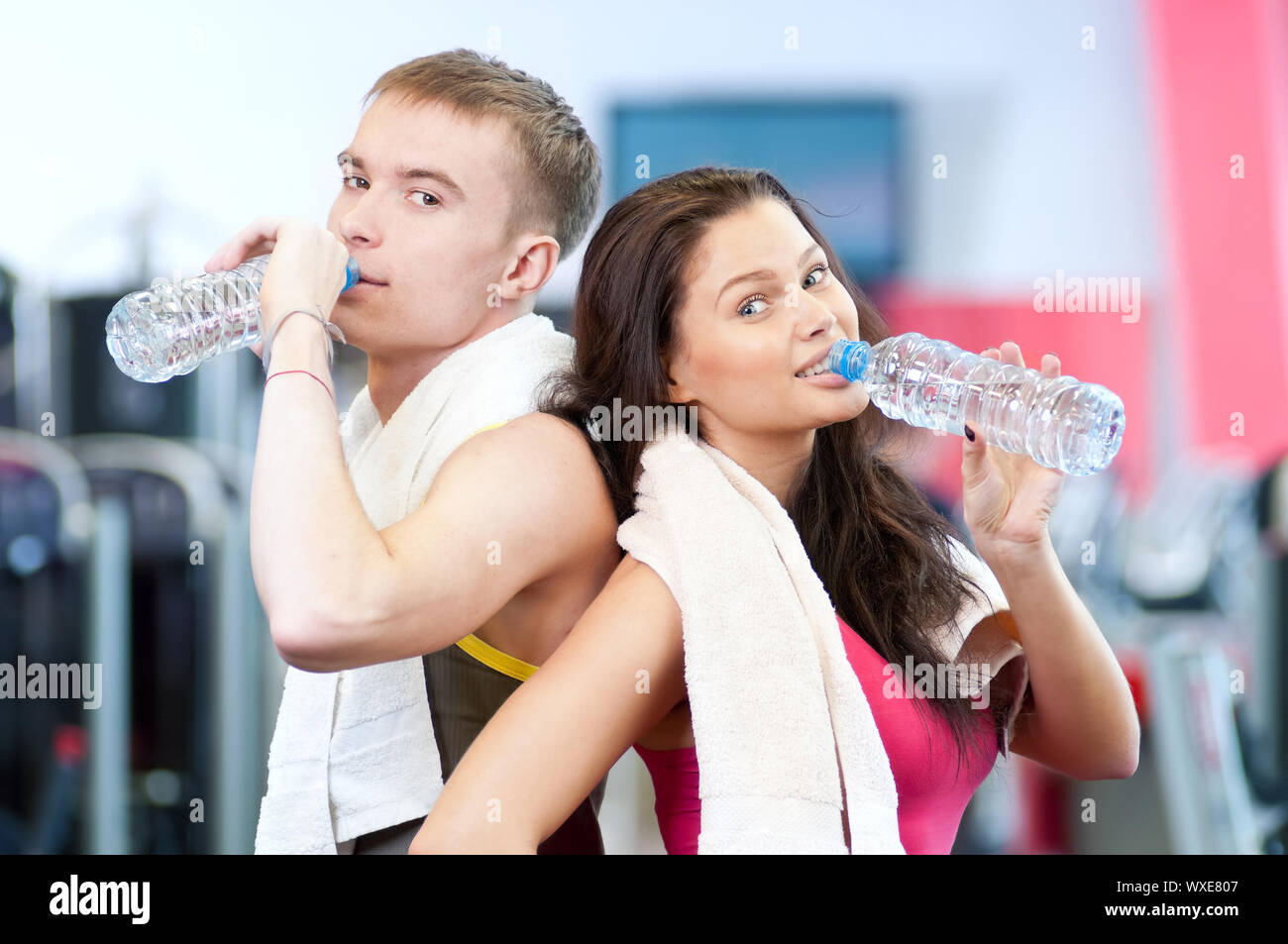 Man and woman drinking water after sport exercises. Fitness gym Stock ...
