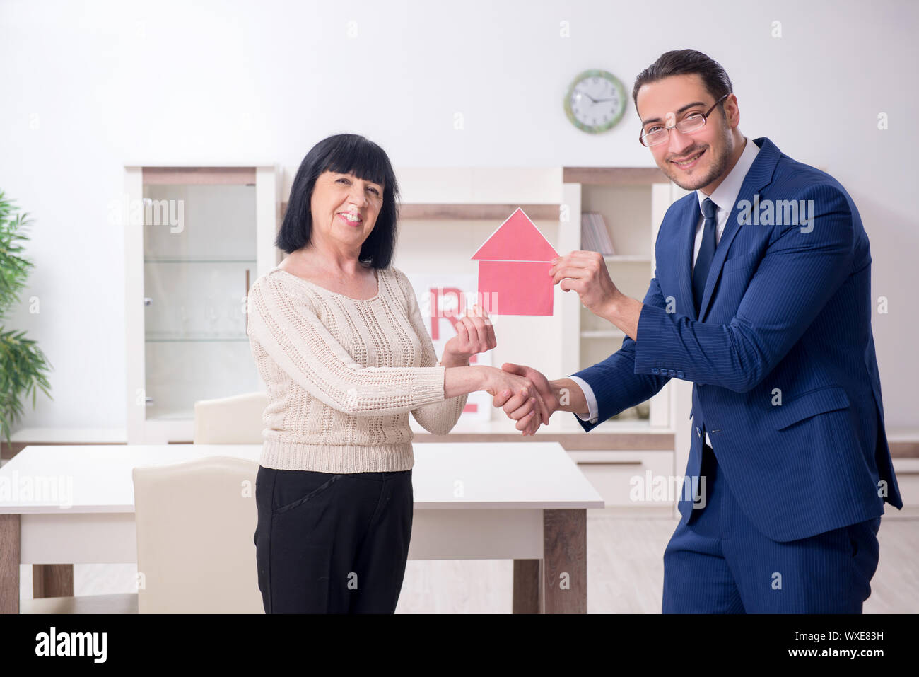 Male real estate agent and female client in the apartment Stock Photo ...