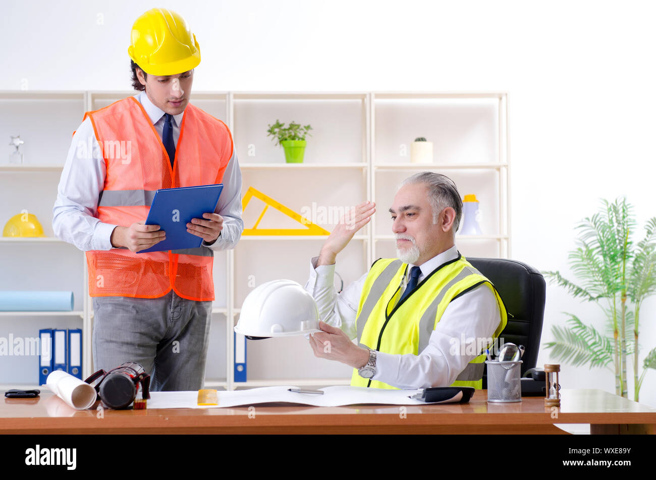 Two engineers colleagues working under project Stock Photo - Alamy