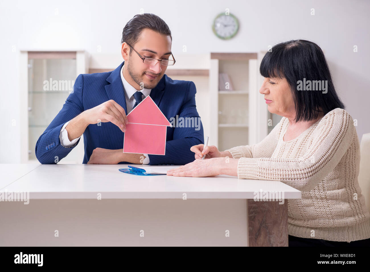 Male real estate agent and female client in the apartment Stock Photo ...