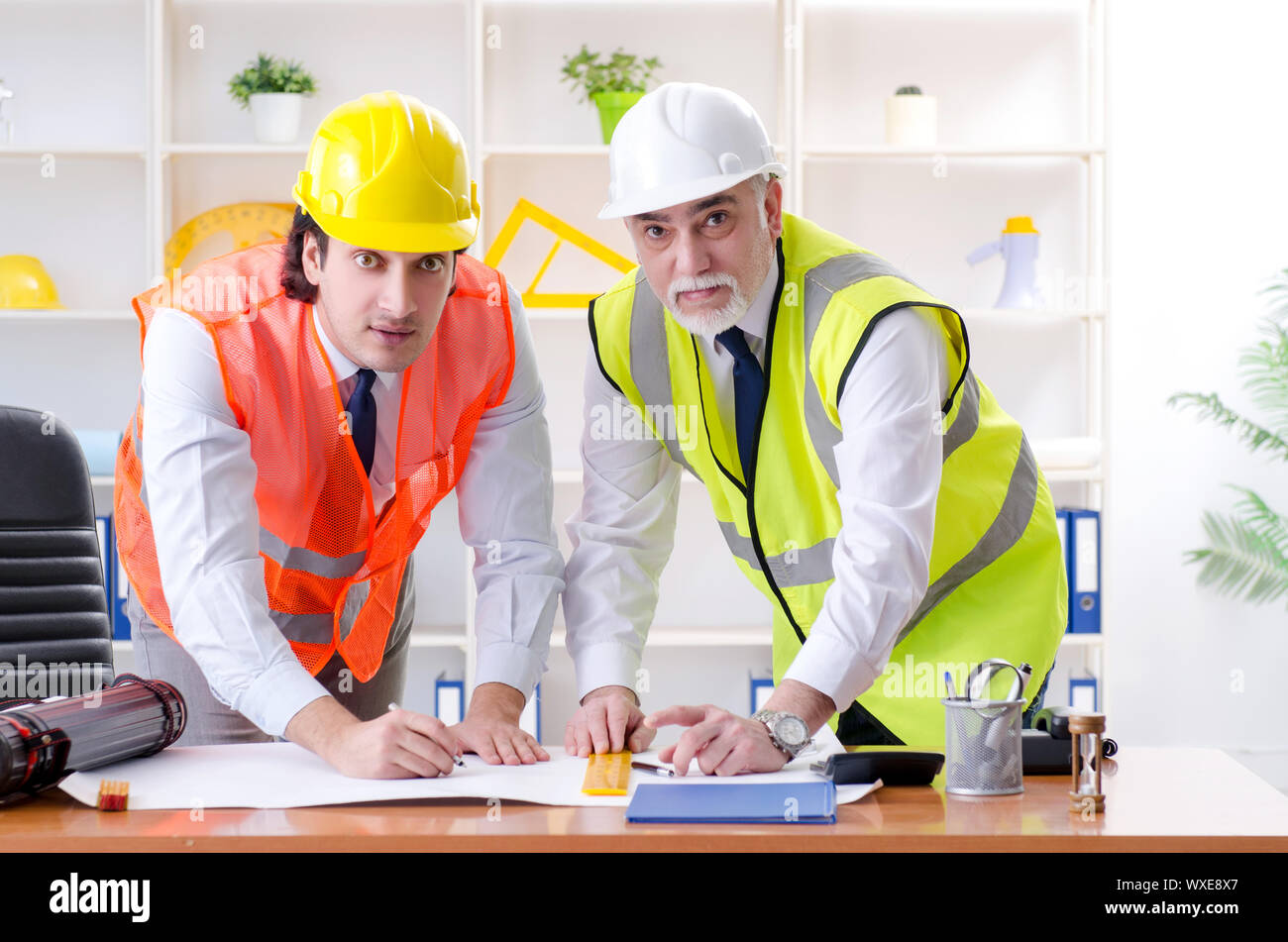 Two engineers colleagues working under project Stock Photo - Alamy