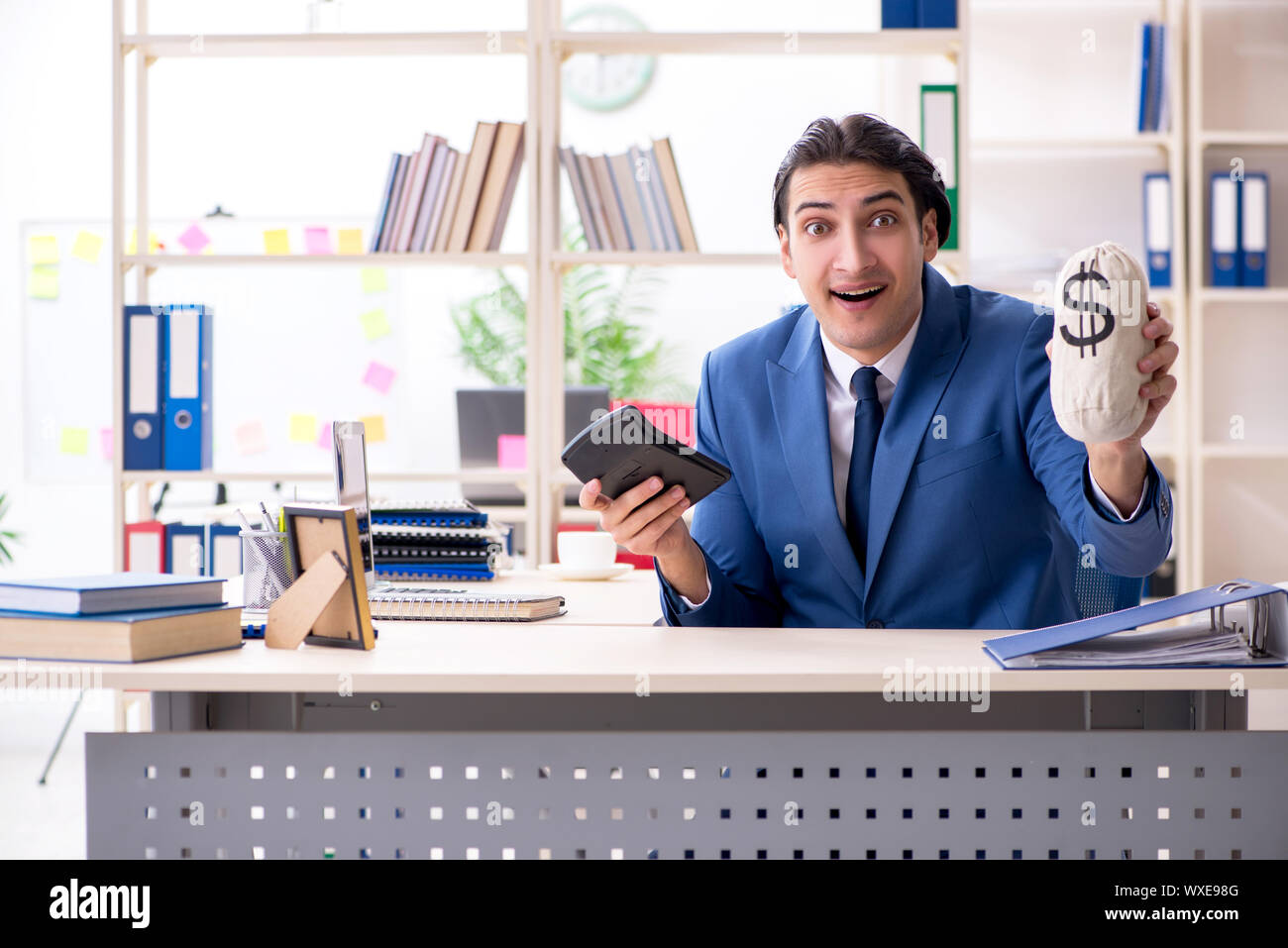 Young handsome employee in the office Stock Photo - Alamy