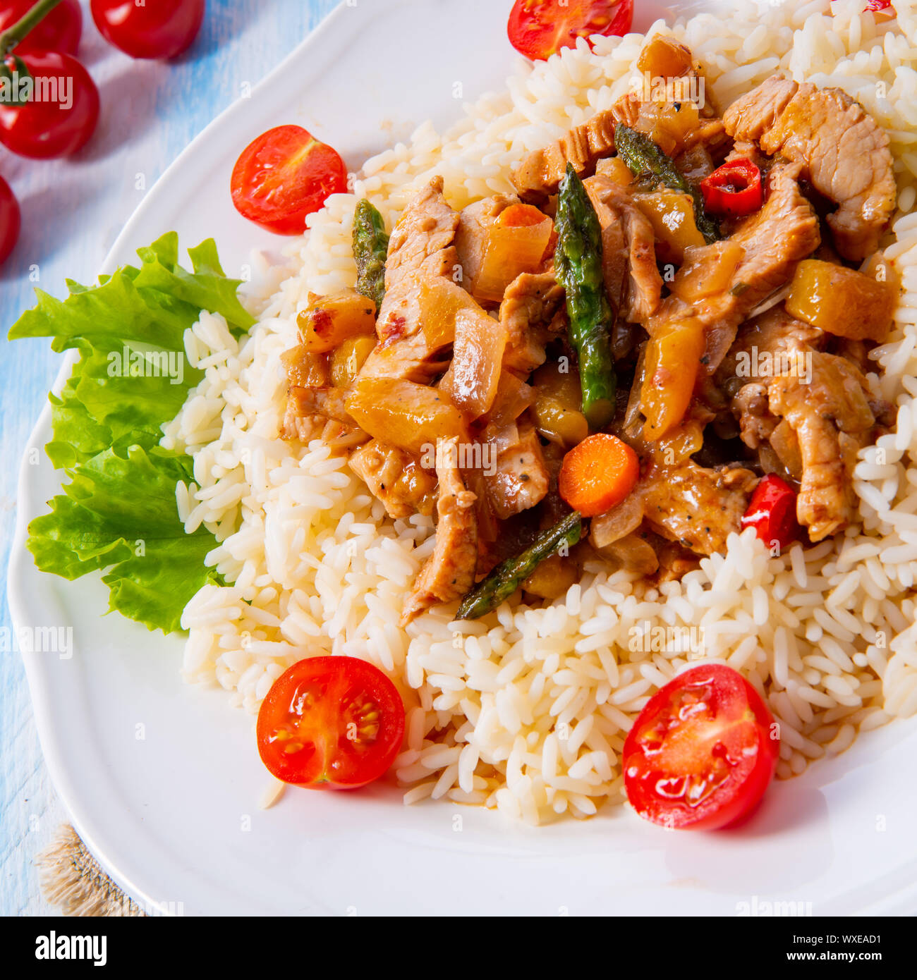 Turkey fricassee on rice with asparagus and paprika Stock Photo - Alamy