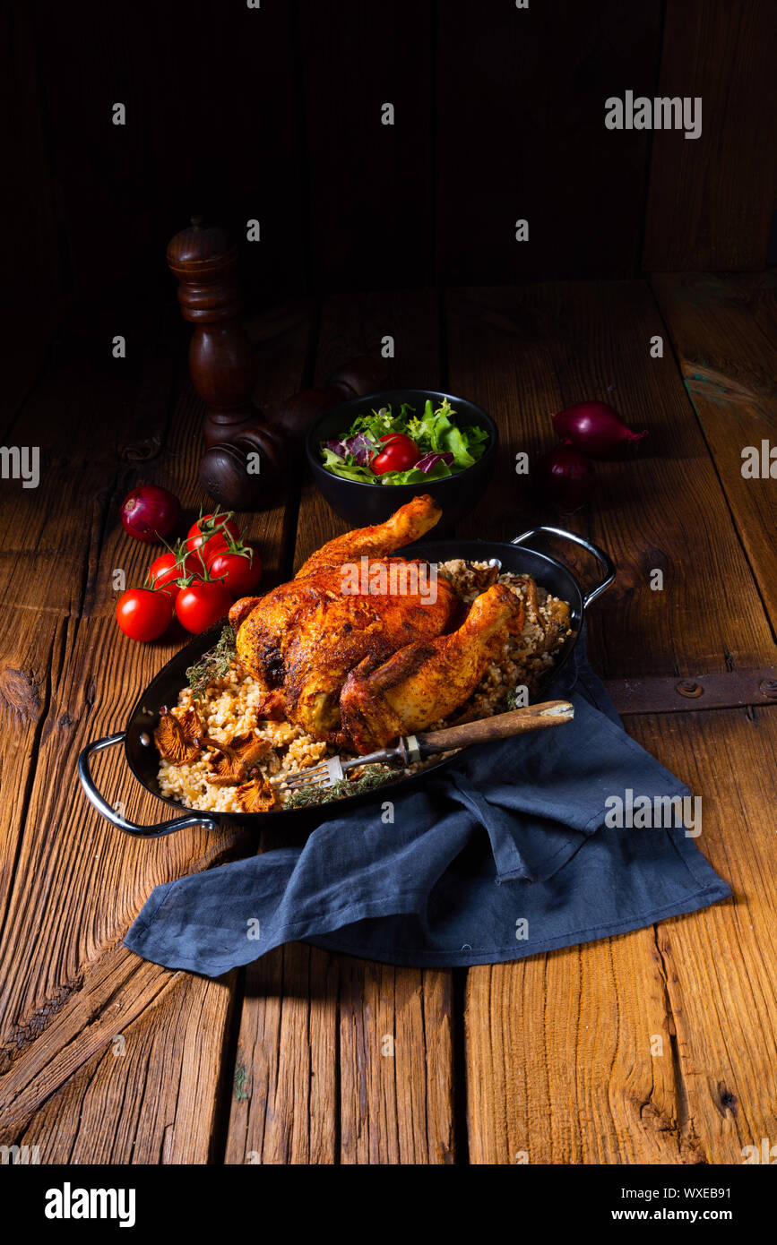 Grilled spicy chicken with barley groats and mushrooms Stock Photo - Alamy