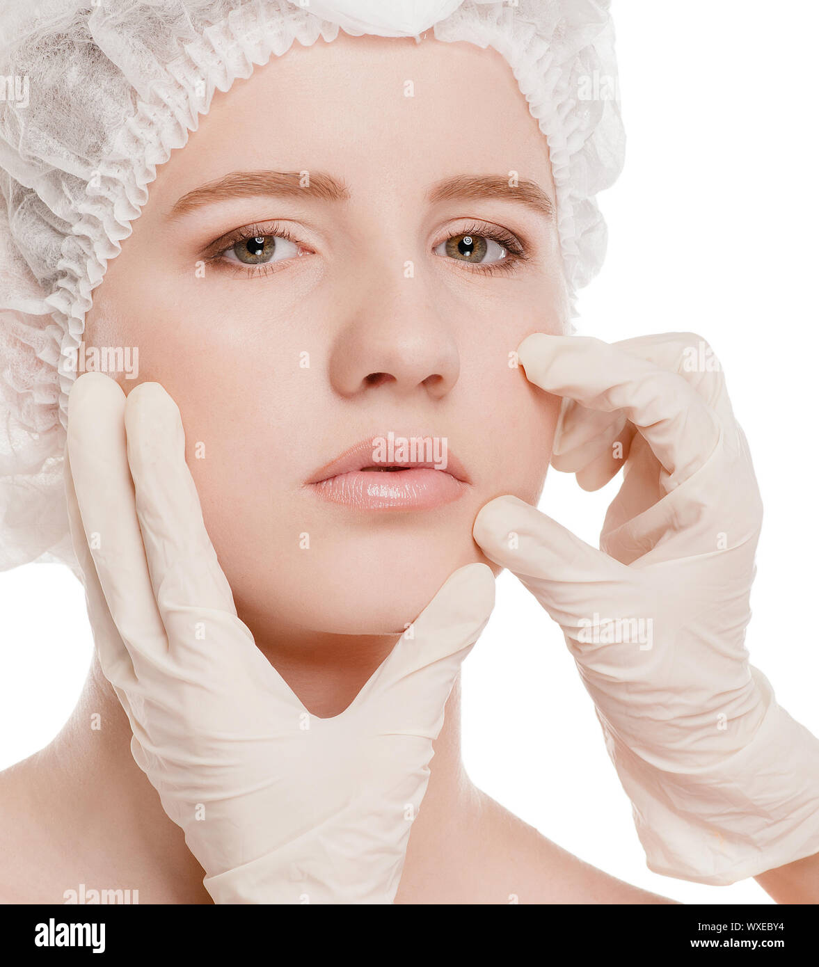 Medical examination face of beautiful woman by hands in glove - close ...