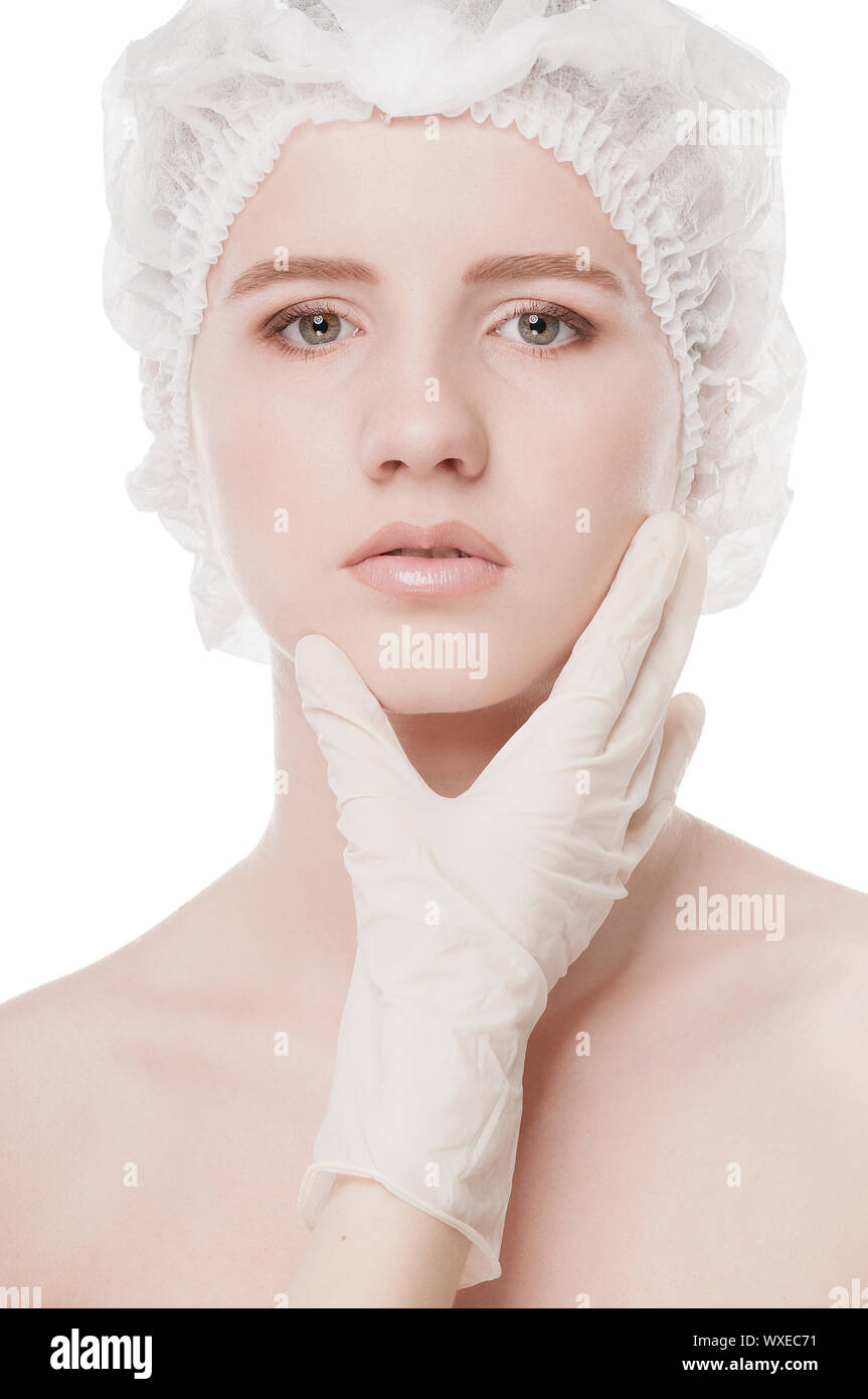 Medical examination face of beautiful woman by hands in glove - close ...