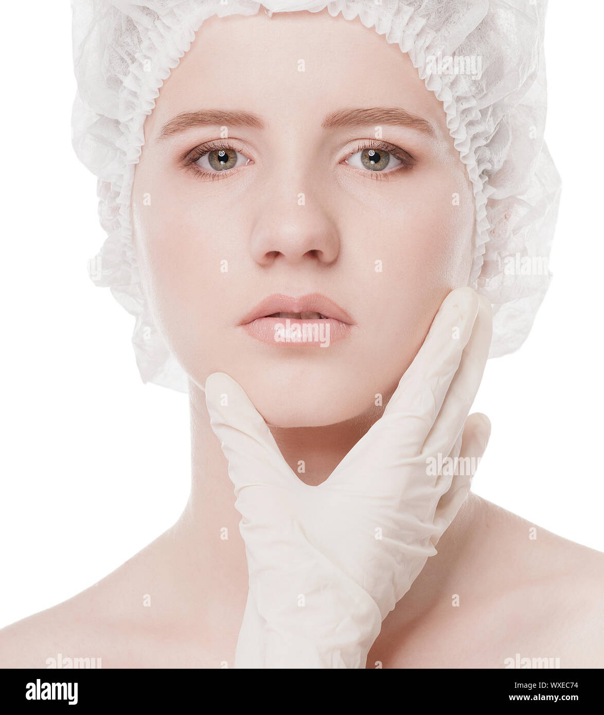 Medical examination face of beautiful woman by hands in glove - close ...